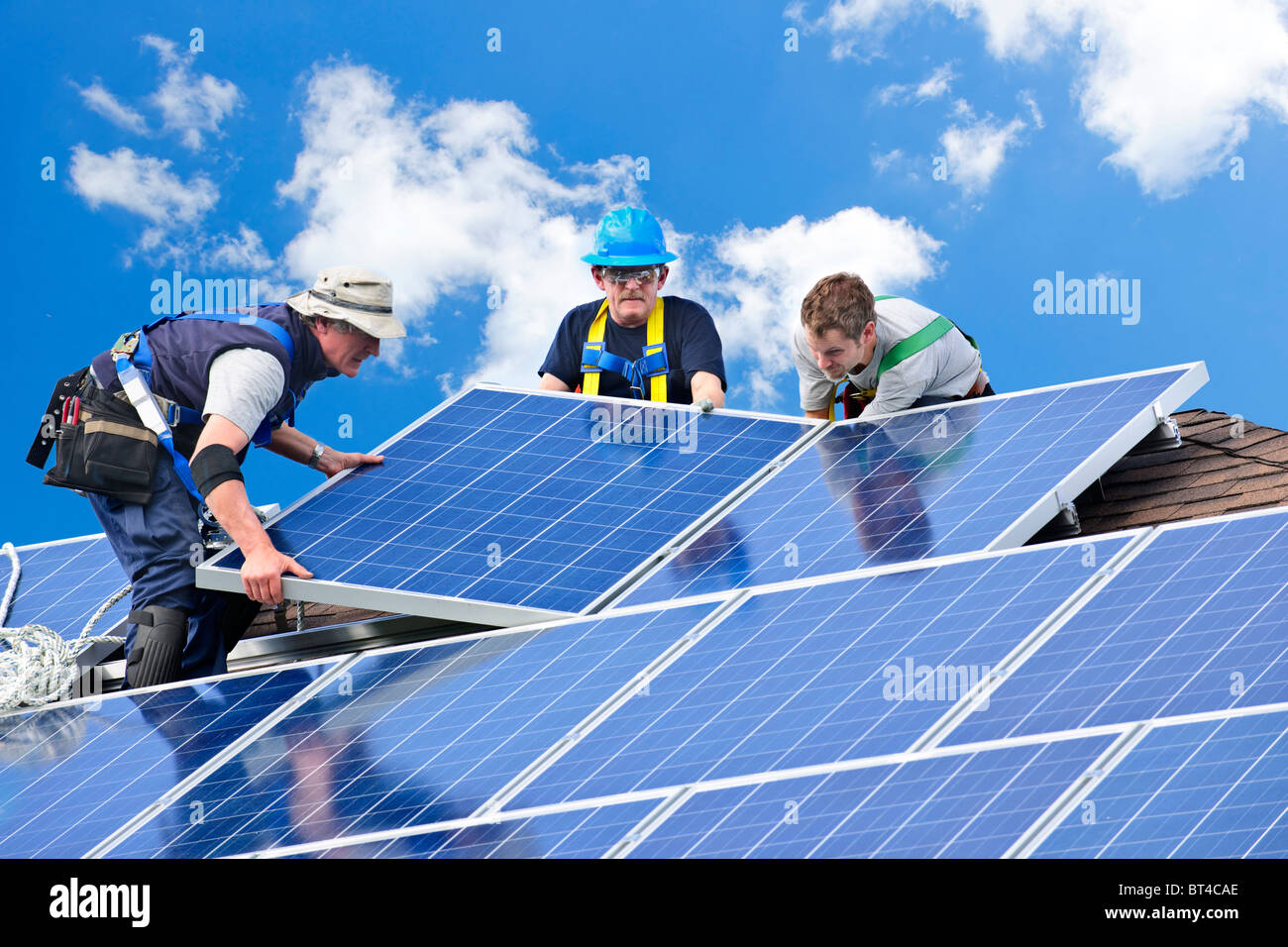 Three workers install solar panel hi-res stock photography and images ...