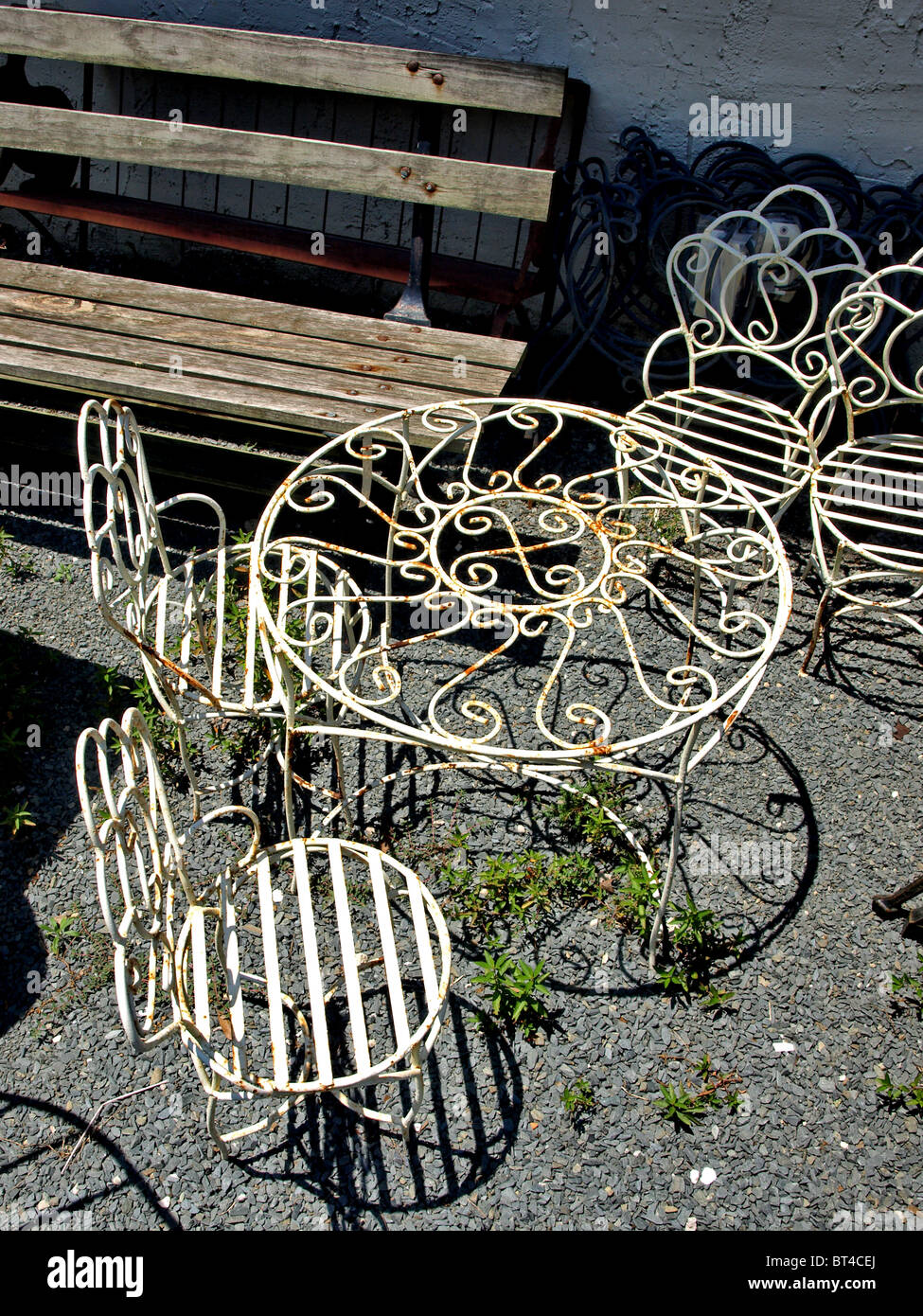 metal outdoor patio furniture white table chairs bench shadows Stock ...