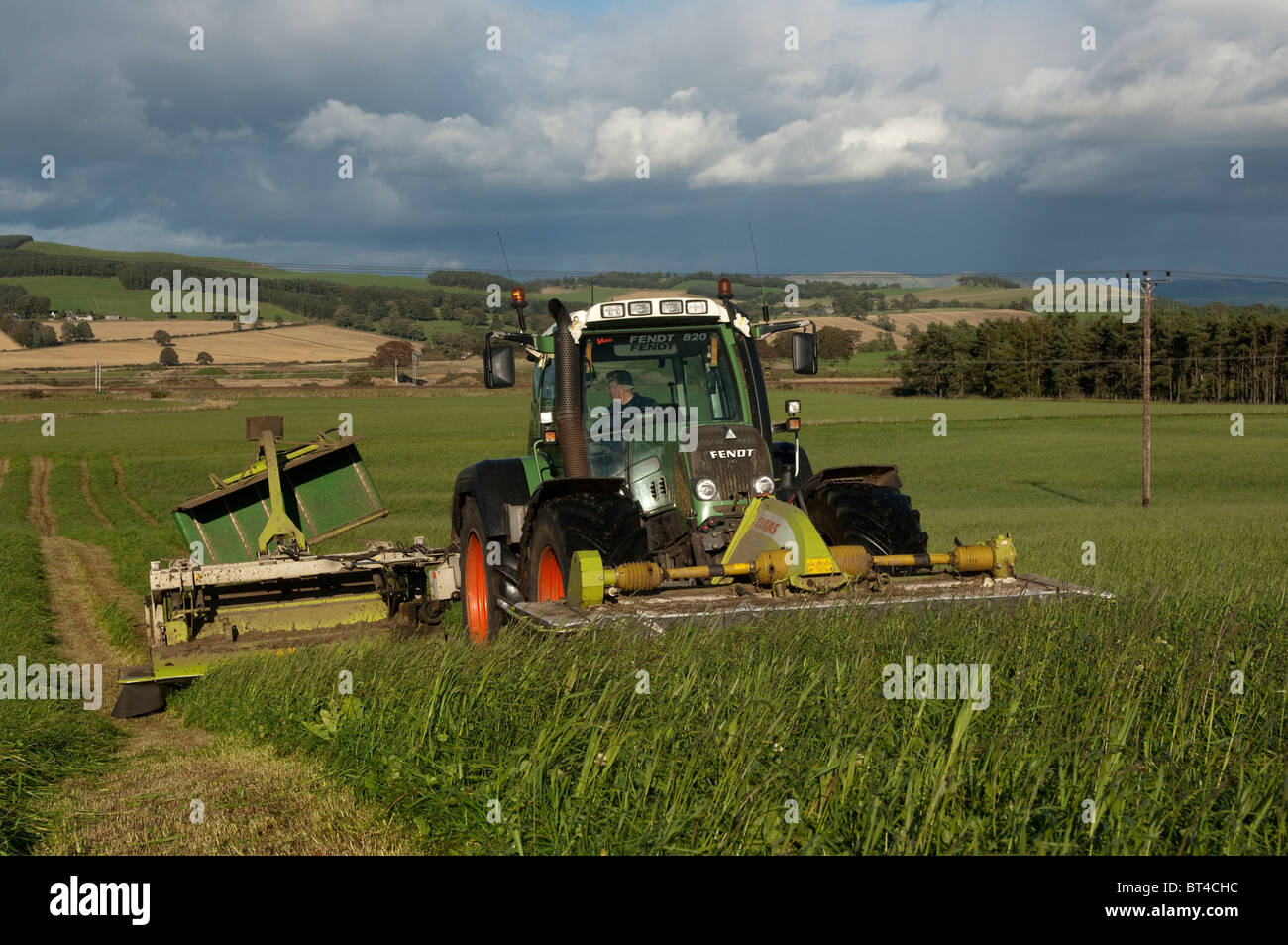 Mowing second cut grass with front and rear mounted mower conditioners ...