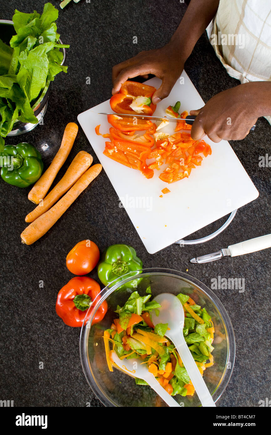 young man cutting vegetables in kitchen Stock Photo - Alamy
