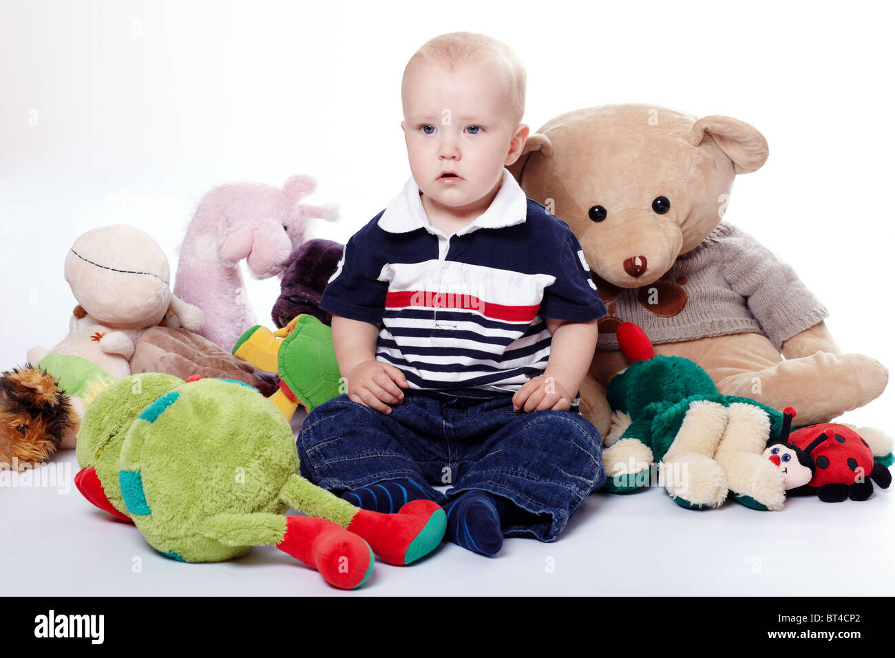 Young boy with plush toys Stock Photo - Alamy