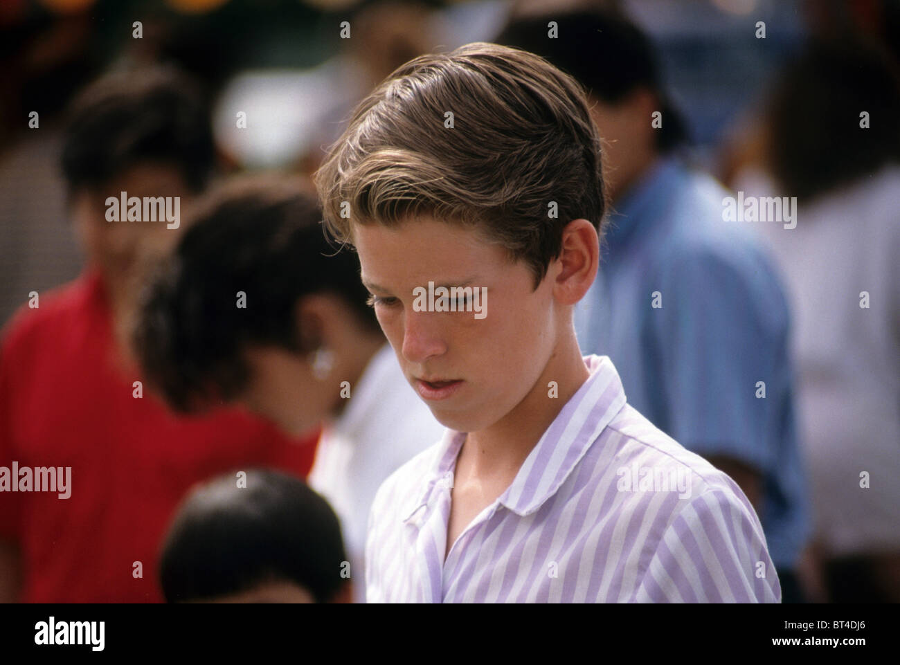 Pre-teen male boy serious listen face expression intent attention tired ...