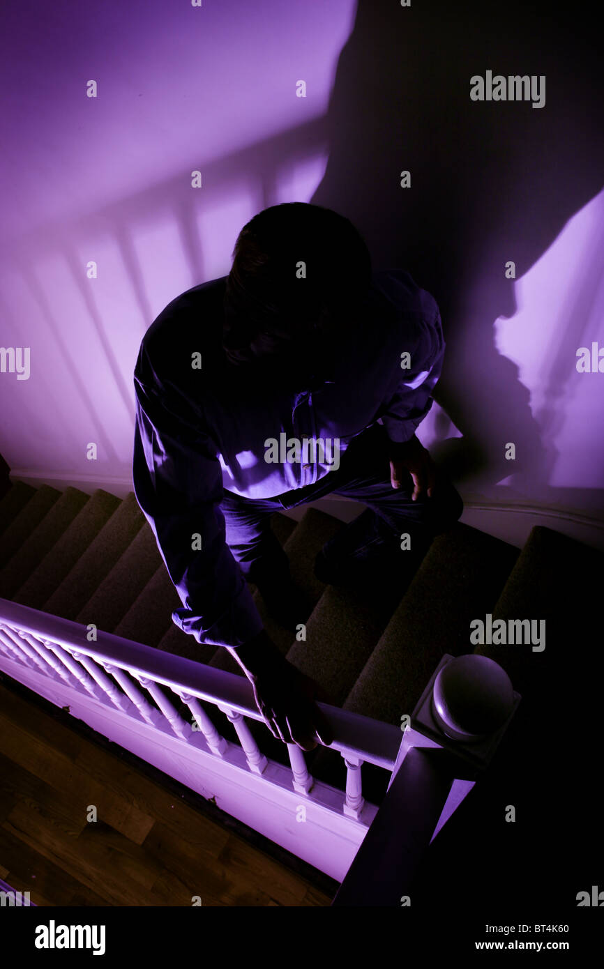 Man walking up dark stairway Stock Photo - Alamy