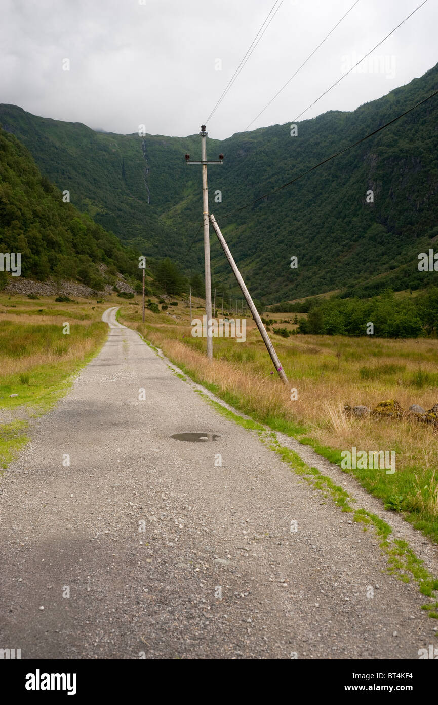 Narrow road in valley Stock Photo - Alamy