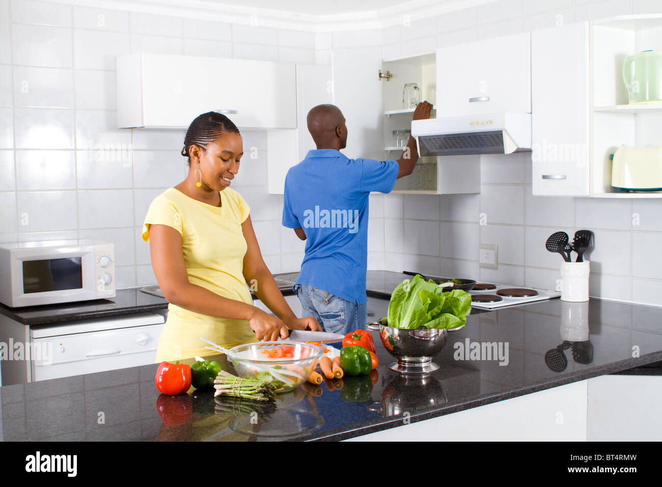 african couple cooking in home kitchen Stock Photo - Alamy