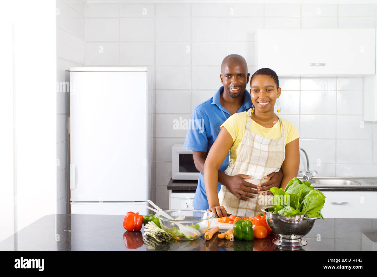young african american couple in kitchen cooking food Stock Photo - Alamy
