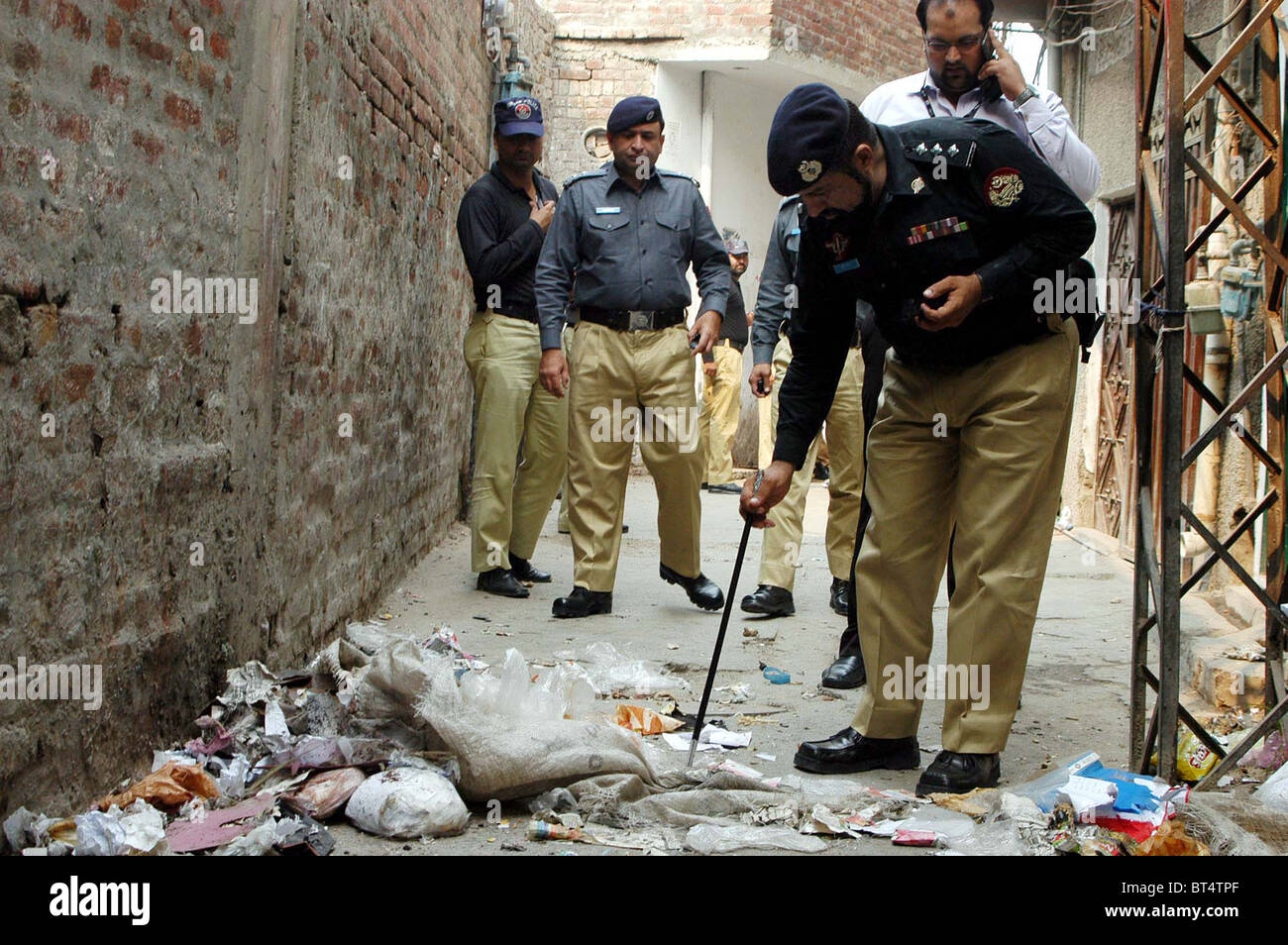 A police official examines the site of cracker blast in Lahore on ...