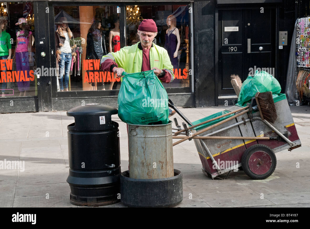 Garbage man collecting the garbage in the street hi-res stock ...