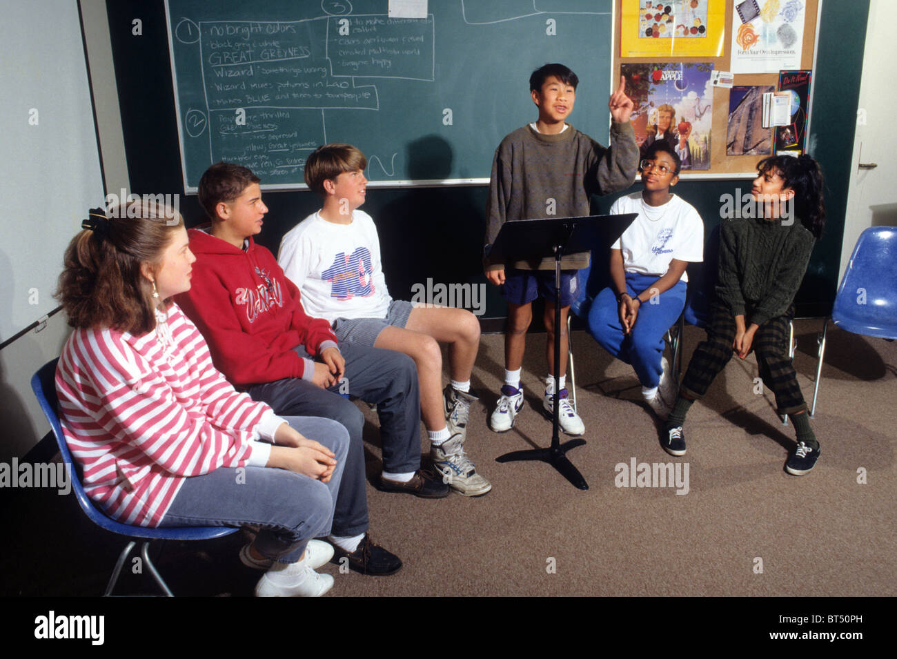 High school student group listen talk speech report mix race attention ...