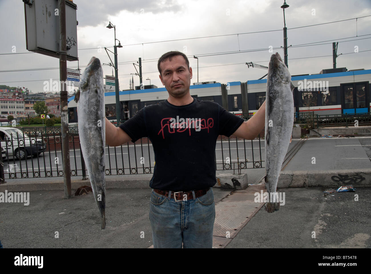 TURKISH MAN HOLDING FROZEN SALMON FISH Stock Photo - Alamy
