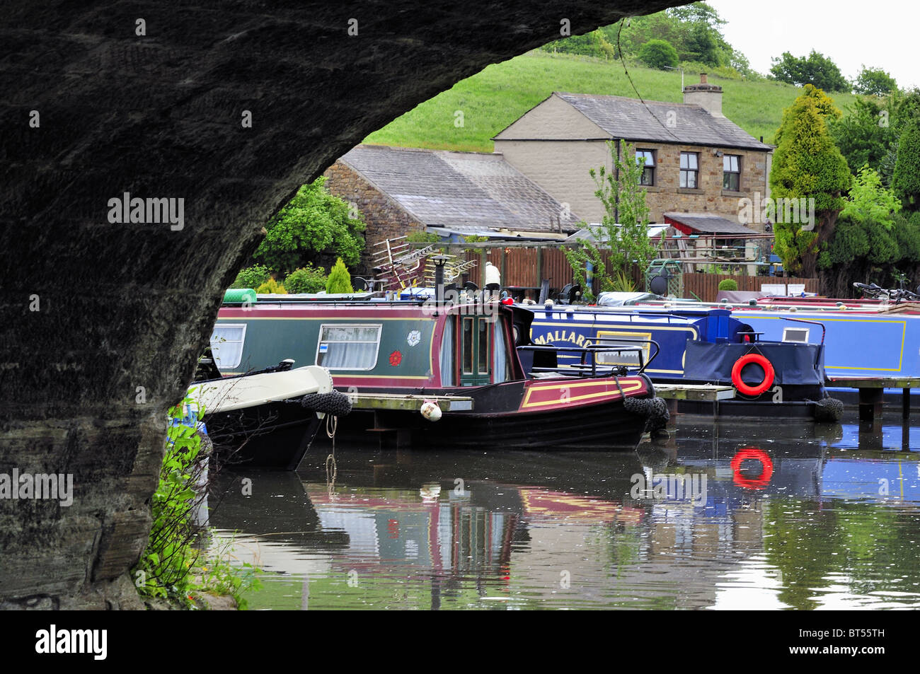 view ,through arch stone bridge, line of Narrow boats ,stone buildings ...