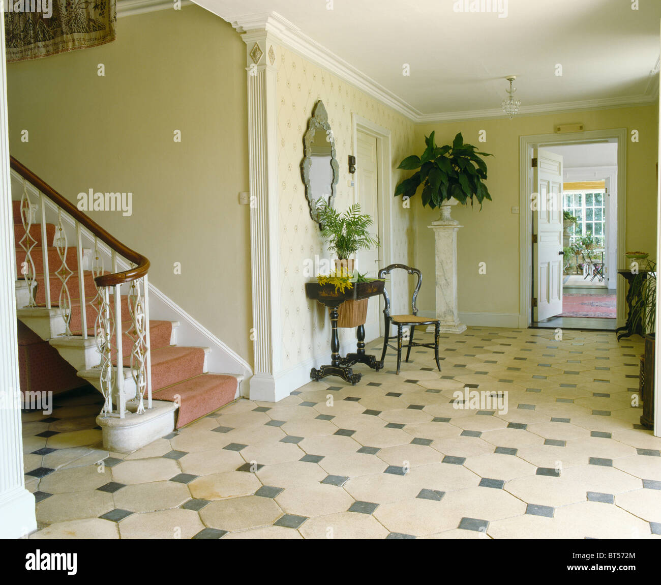 Cream+black tiled floor in large traditional cream country hall Stock ...