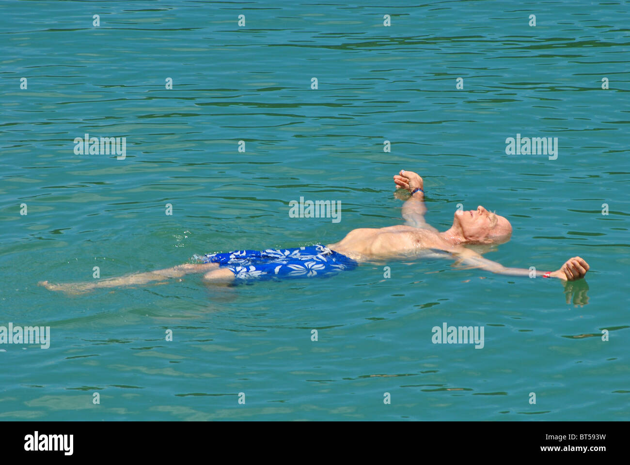 Elderly tourist floating on his back in Halong Bay, Vietnam Stock Photo ...