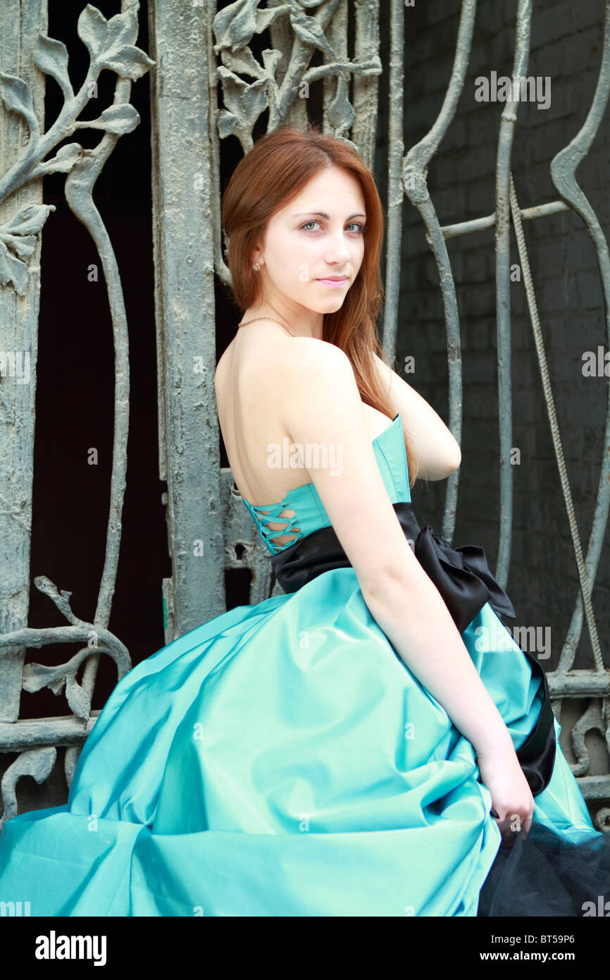 Romantic girl in the beautiful dress near the fence Stock Photo - Alamy