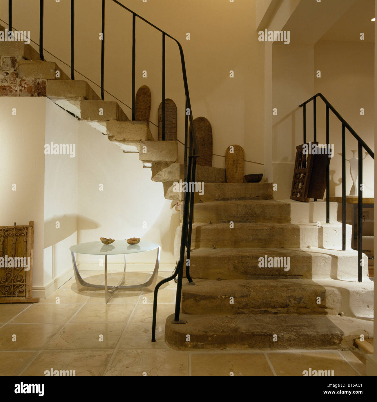 Stone flooring and staircase with metal banisters in country hall Stock ...