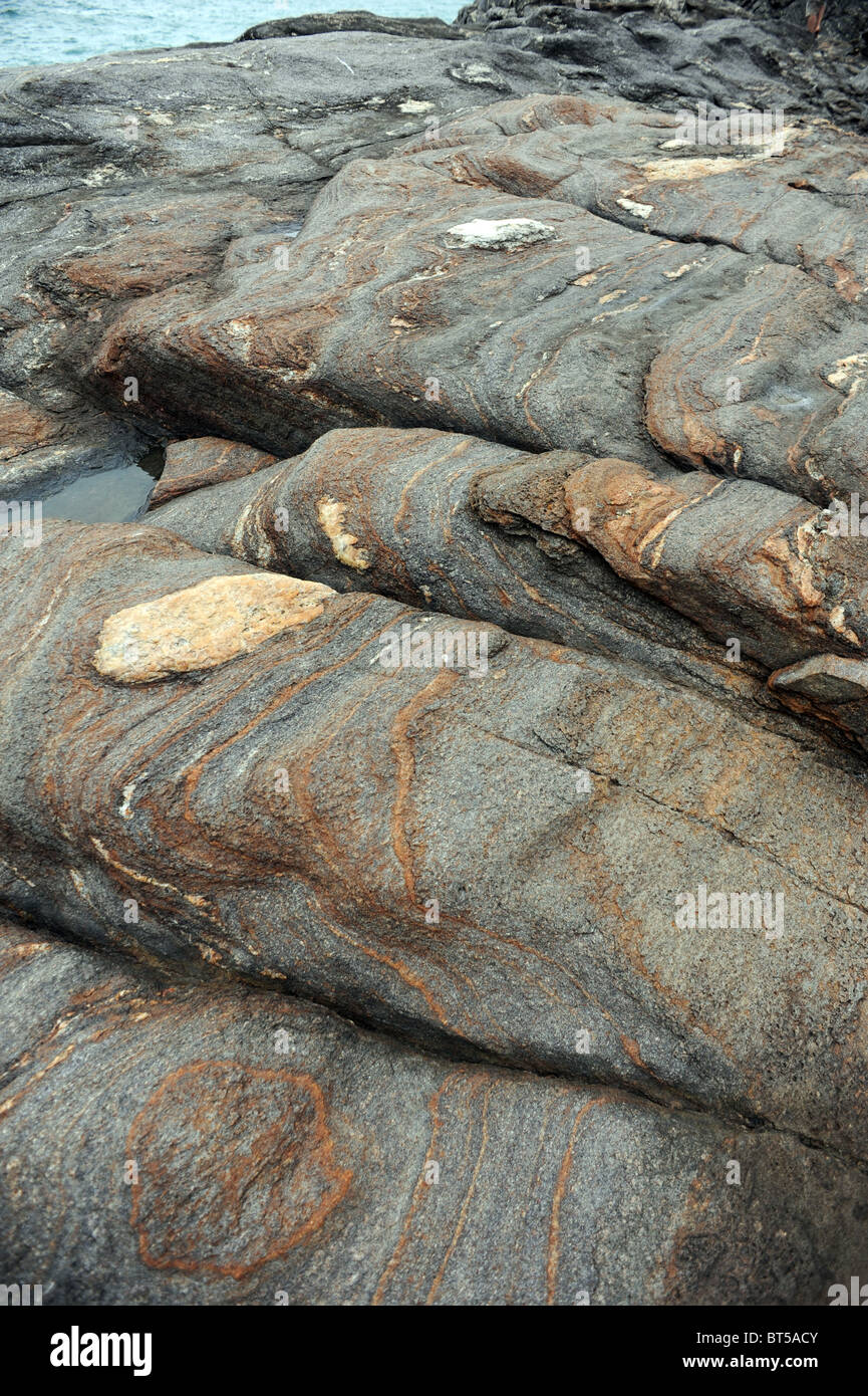 Layers of rock and minerals by the beach in Buzios, also known as the ...