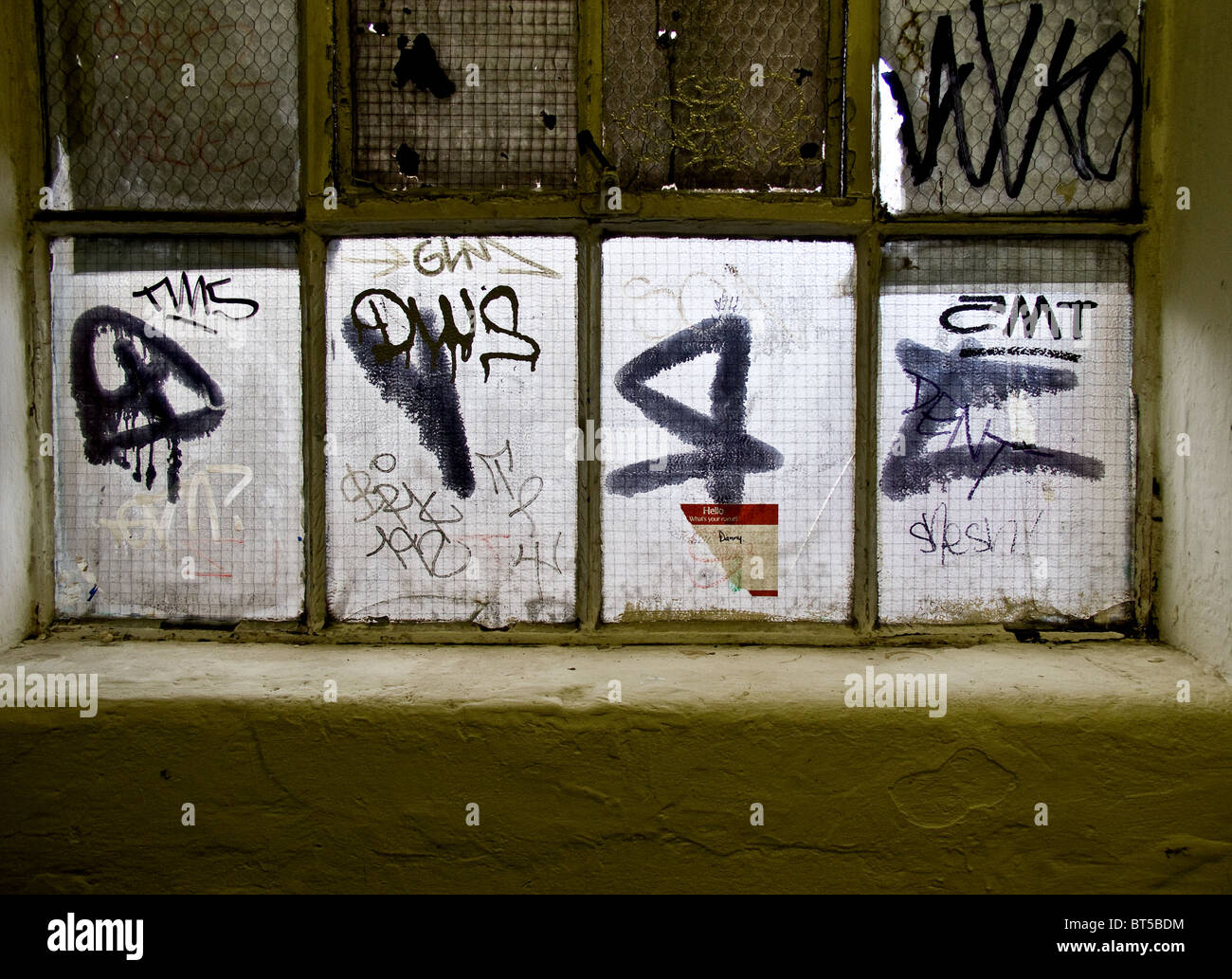 A window covered in graffiti. Photo by Gordon Scammell Stock Photo - Alamy