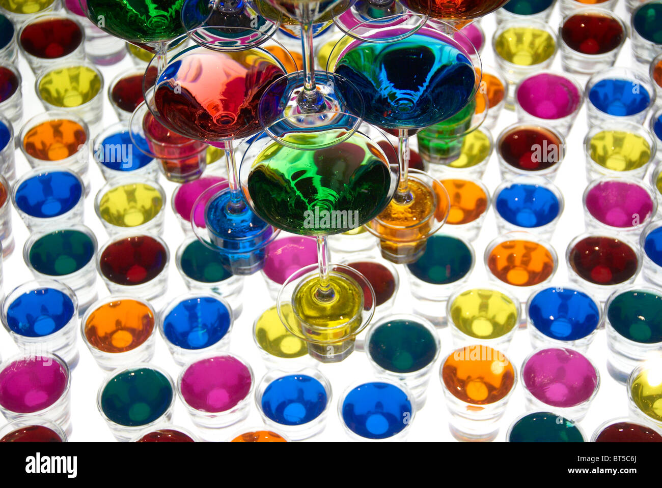 Coloured cocktail glasses on table Stock Photo - Alamy