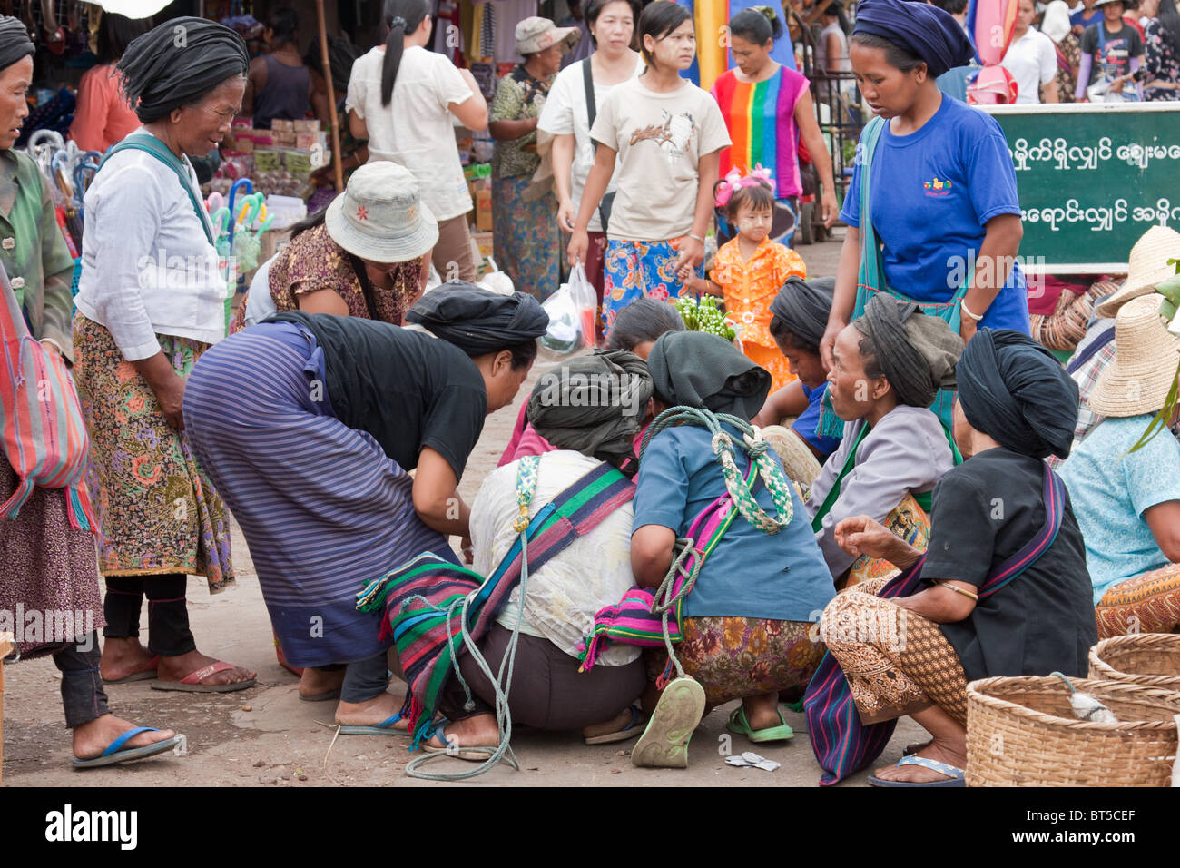 A group of minority women who work as labors check something out in the ...