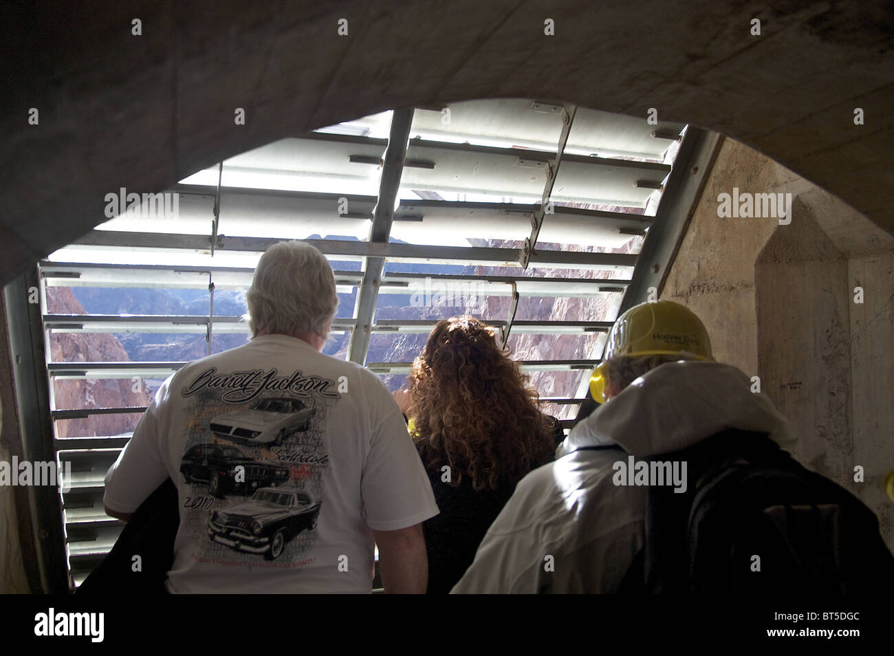 People on a guided tour inside the Hoover Dam's facilities look out ...