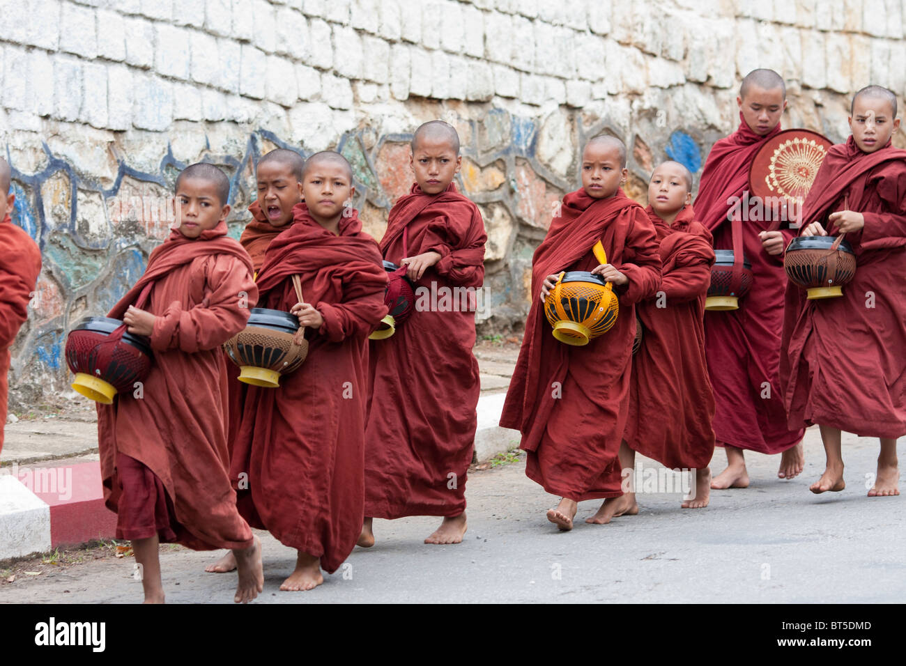 novice monks on their daily alms ceremony Stock Photo - Alamy