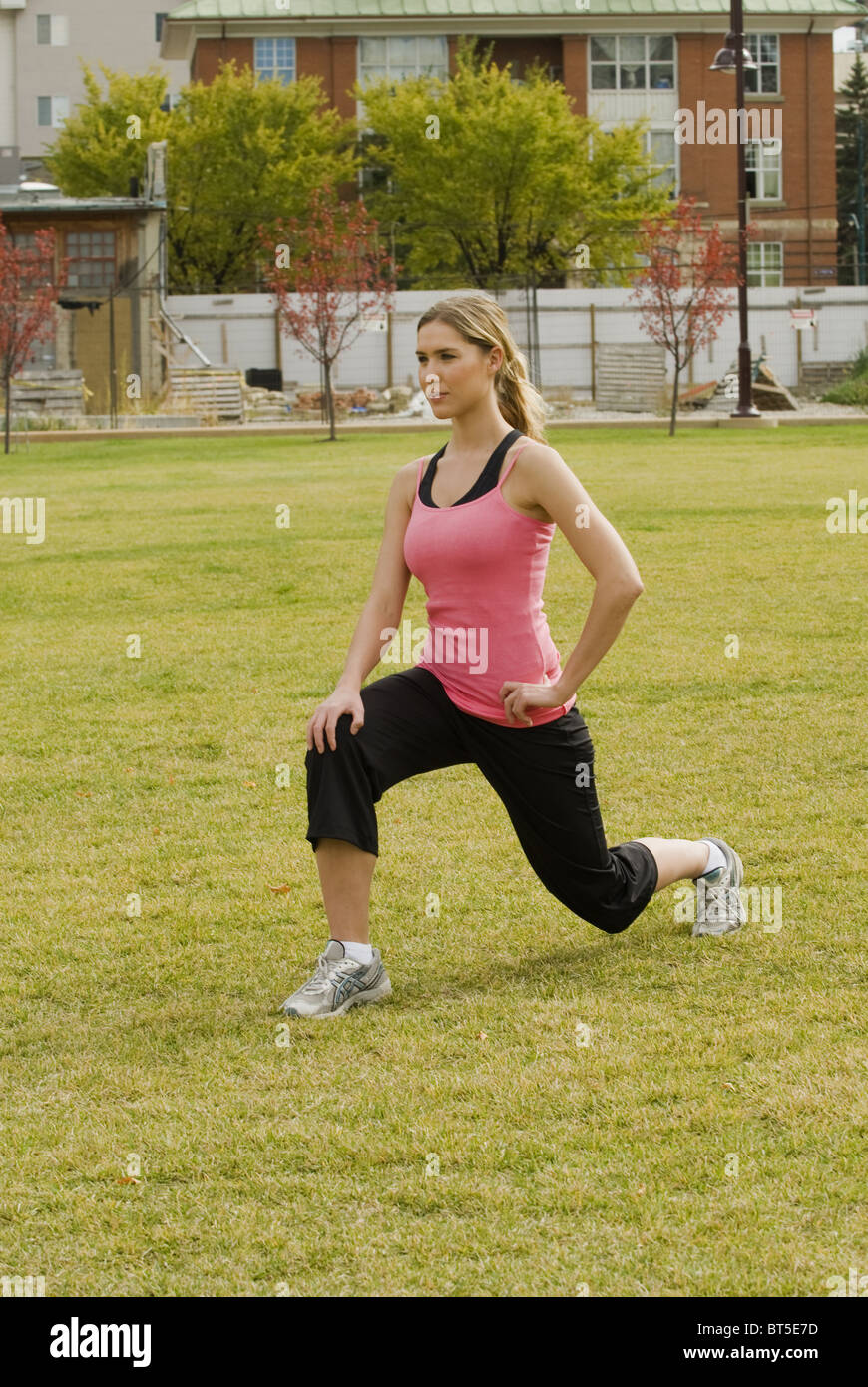 Outdoor spring training exercise in city park showing beautiful young ...