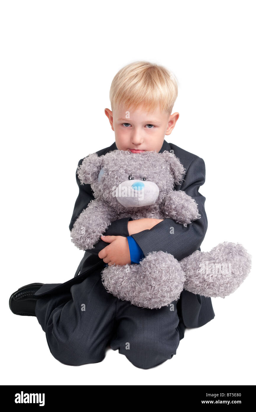 Portrait of a serious young boy and his teddy bear Stock Photo - Alamy