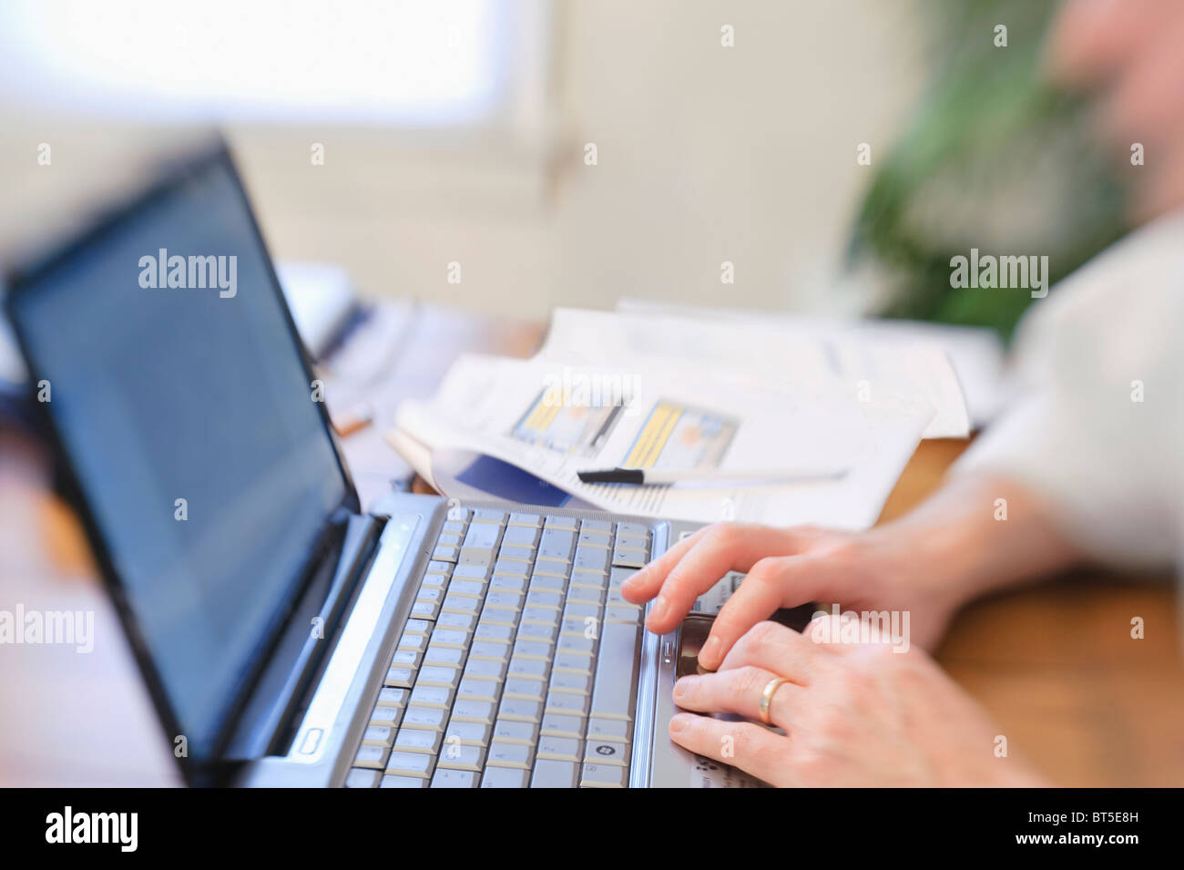 Man working on laptop computer hands on keyboard touch pad selective ...