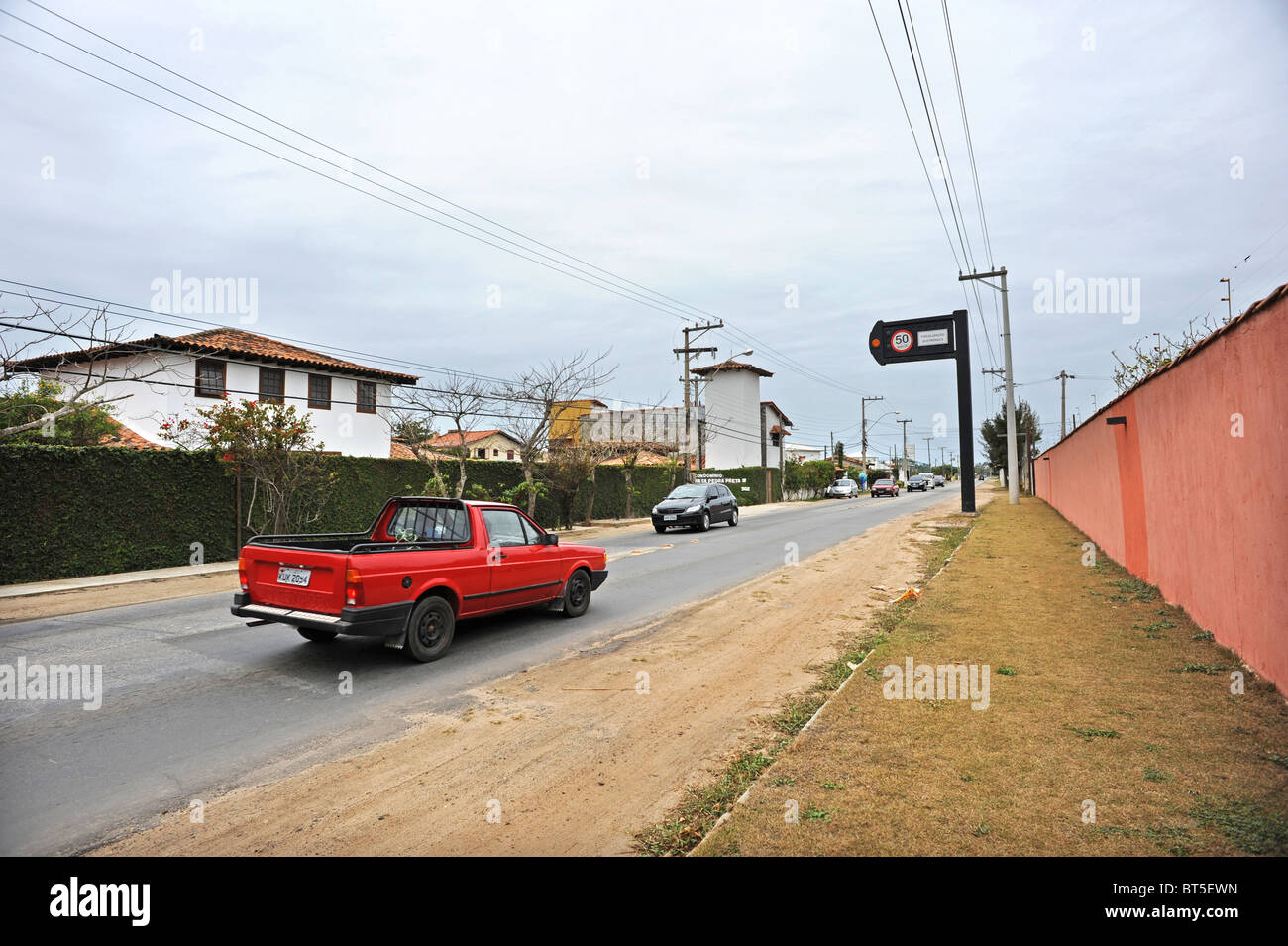 Cars pass through an electronic speed camera on the main road into ...