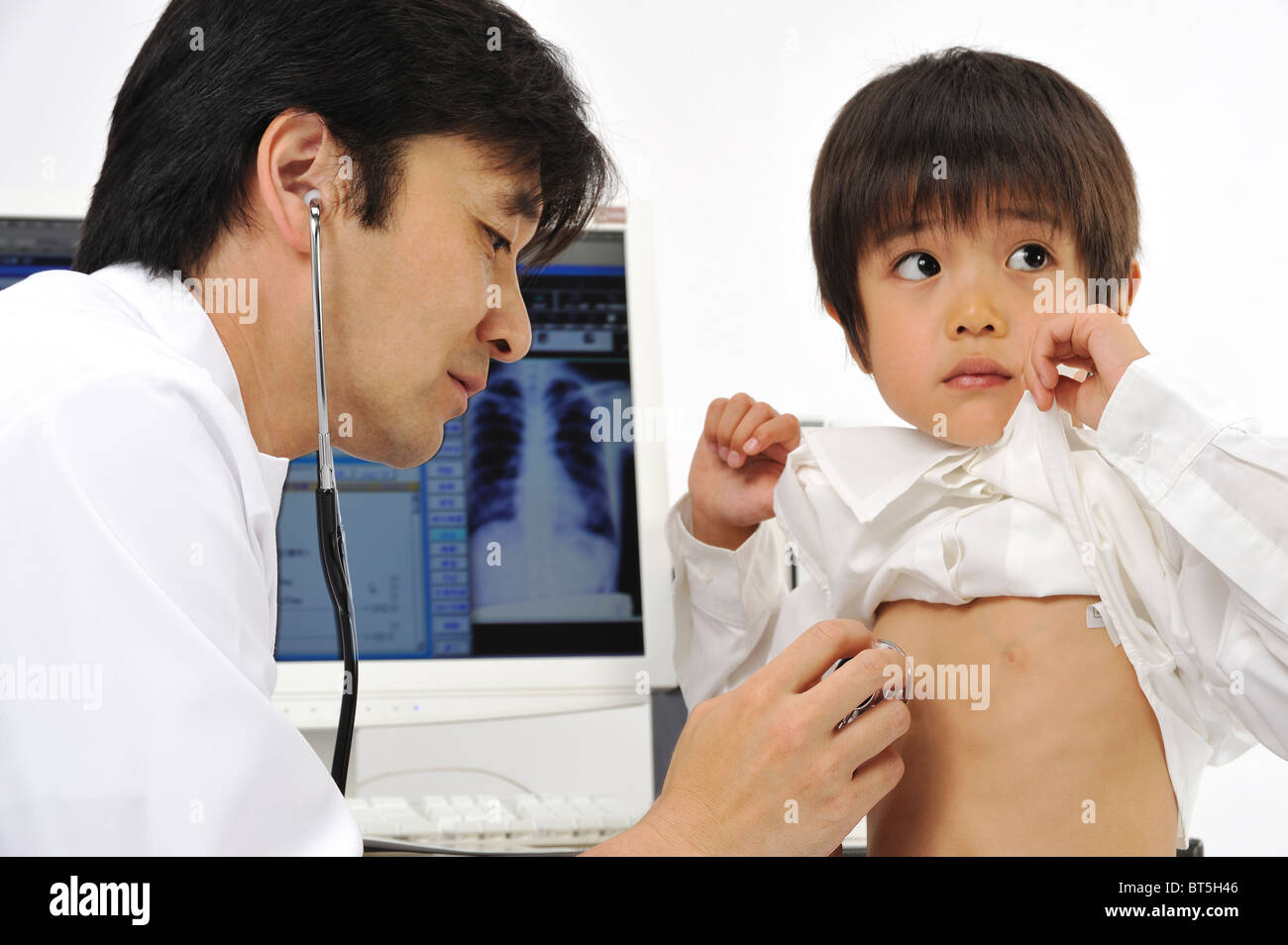 Male doctor examining boy Stock Photo - Alamy