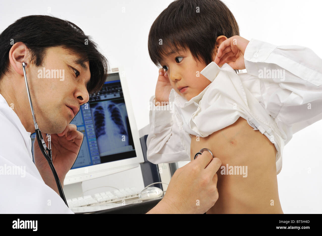 Male doctor examining boy Stock Photo - Alamy