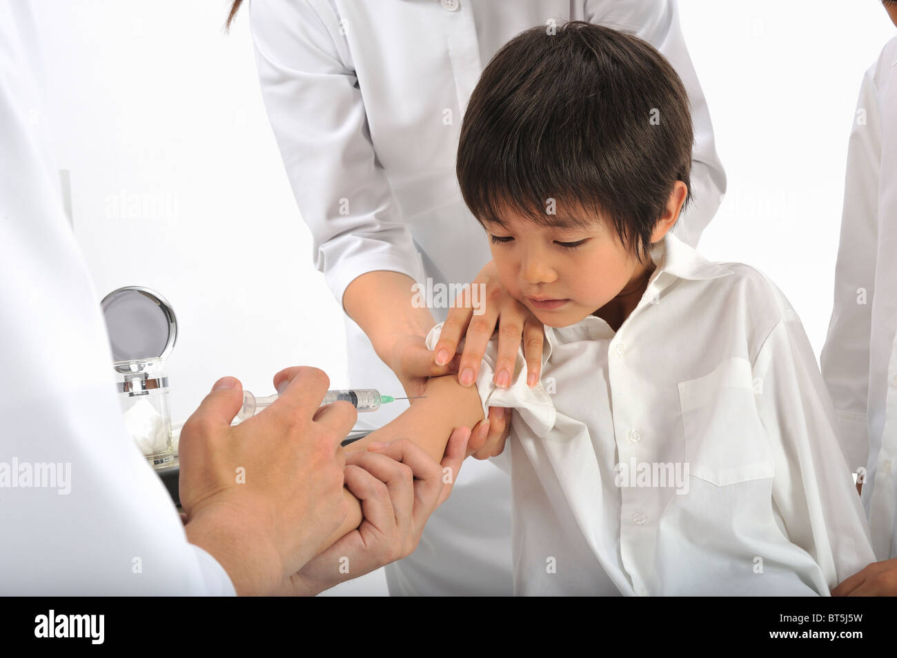 Male doctor and female nurse giving boy injection Stock Photo - Alamy