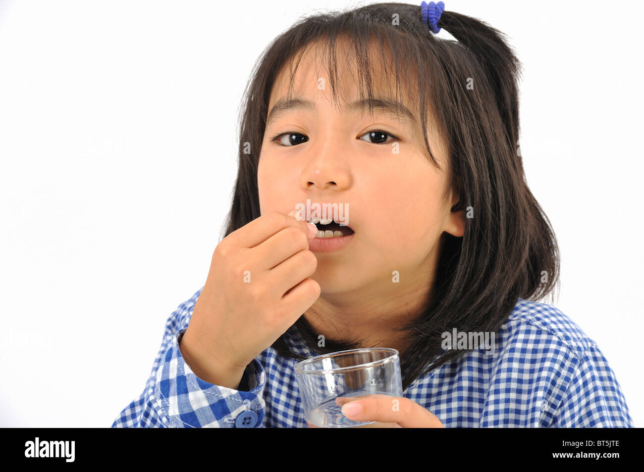 Girl taking medicine Stock Photo - Alamy