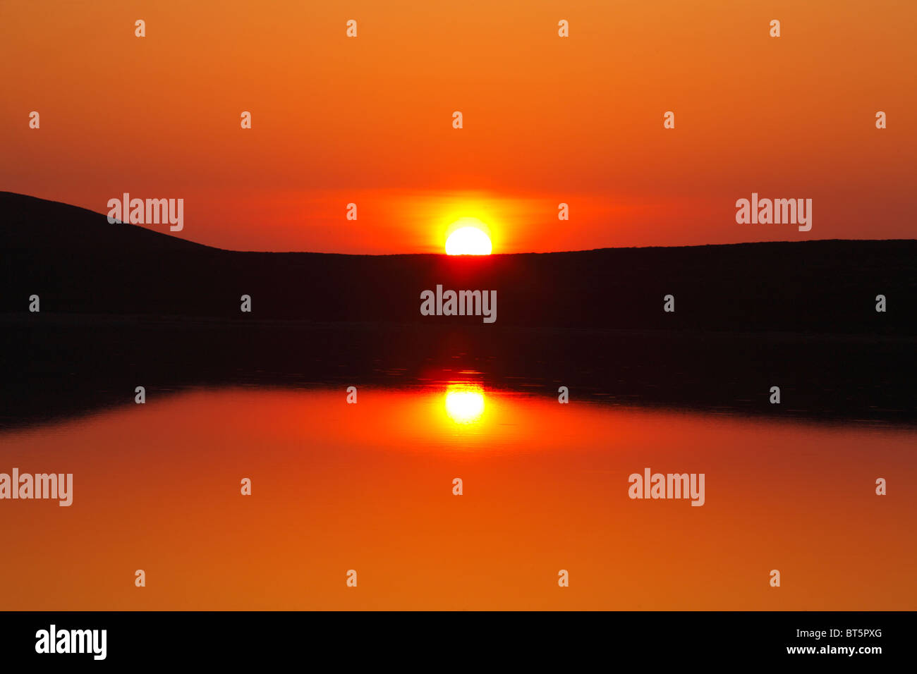 The Sun setting over Glaslyn a mountain lake near Plynlimon in the ...