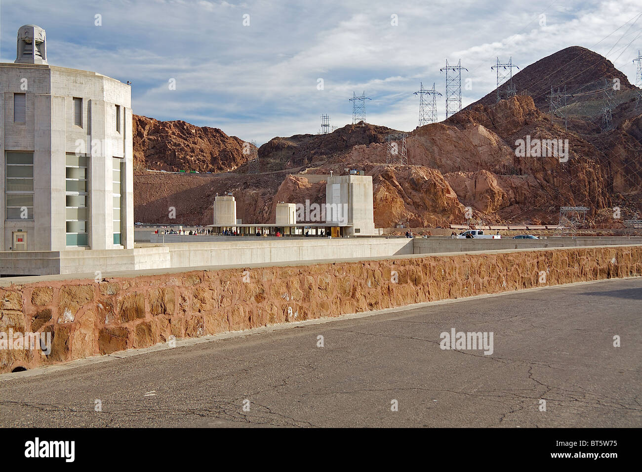 A Hoover Dam intake tower to the left and the rocky landscape ...
