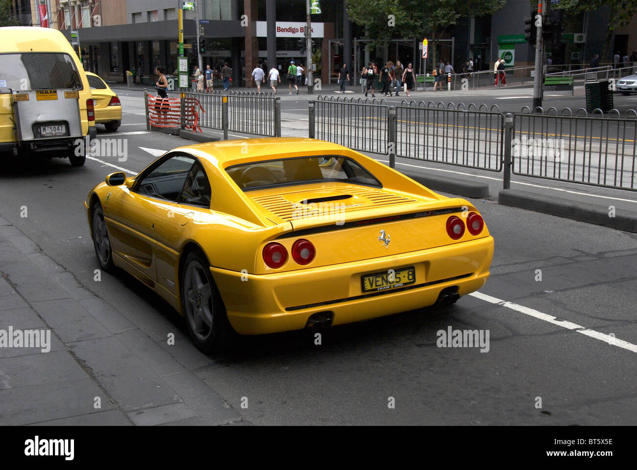 Yellow Ferrari 355 Berlinetta sports car on the street in the city of ...