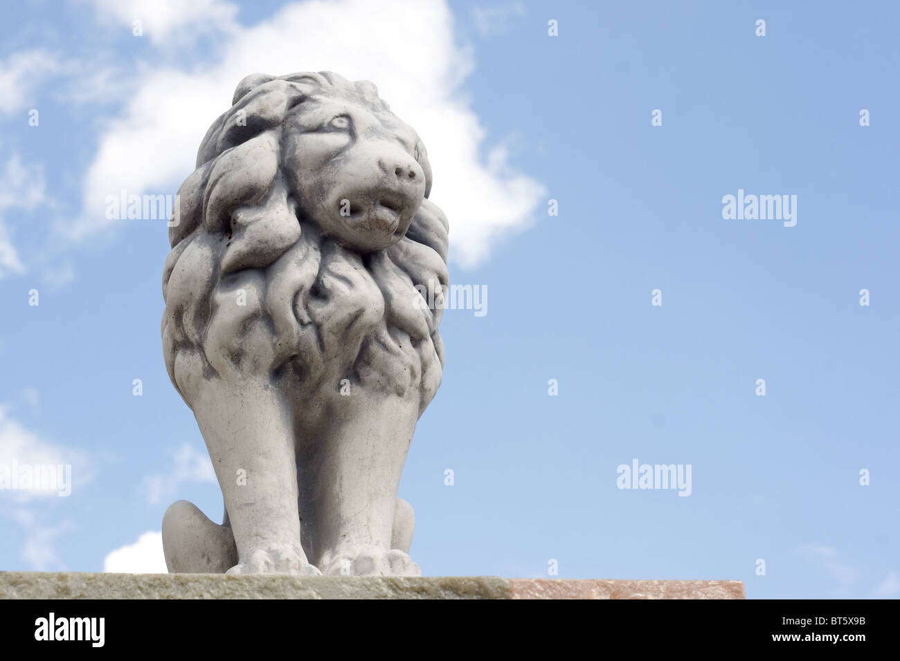 cement lion on a blue sky Stock Photo - Alamy