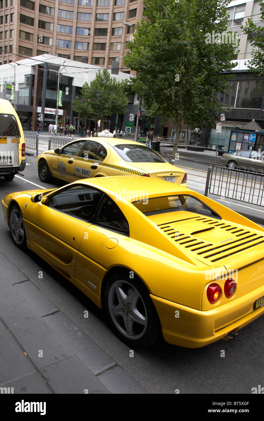 Yellow Ferrari 355 Berlinetta sports car on the street in the city of ...