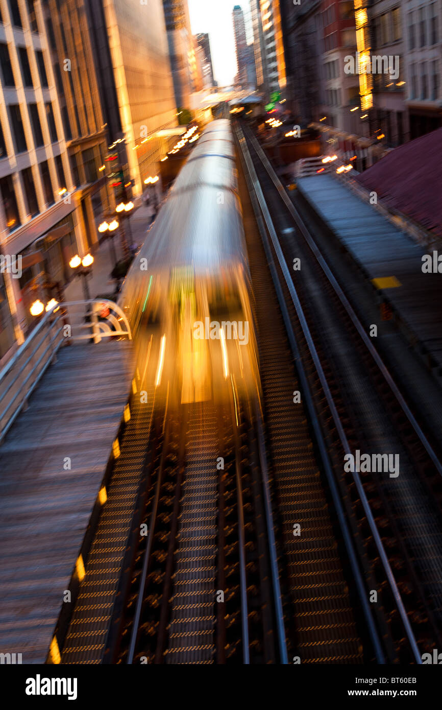 Sunrise illuminates a train in the Chicago rapid transit system known ...