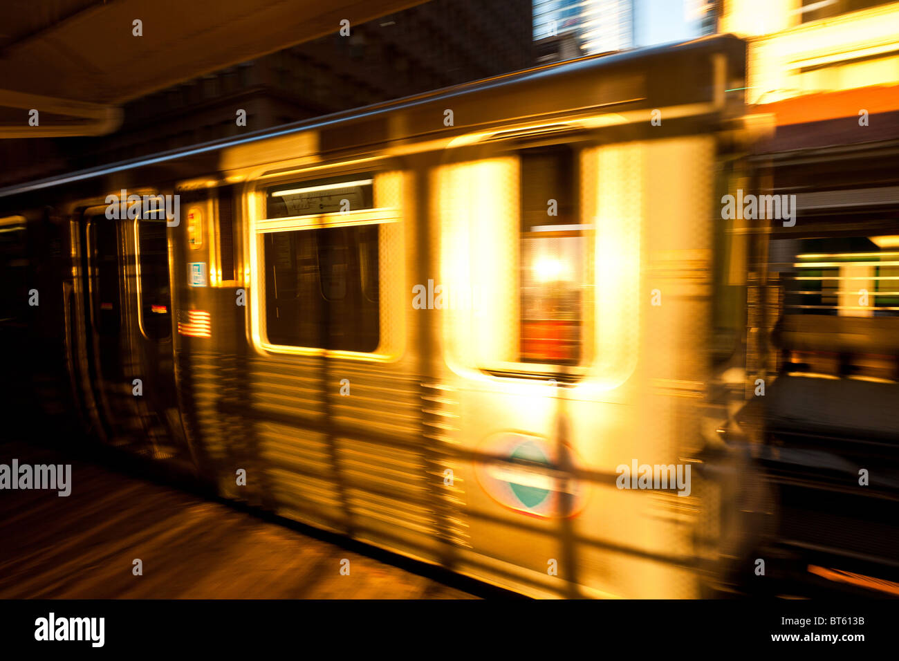Sunrise illuminates a train in the Chicago rapid transit system known ...