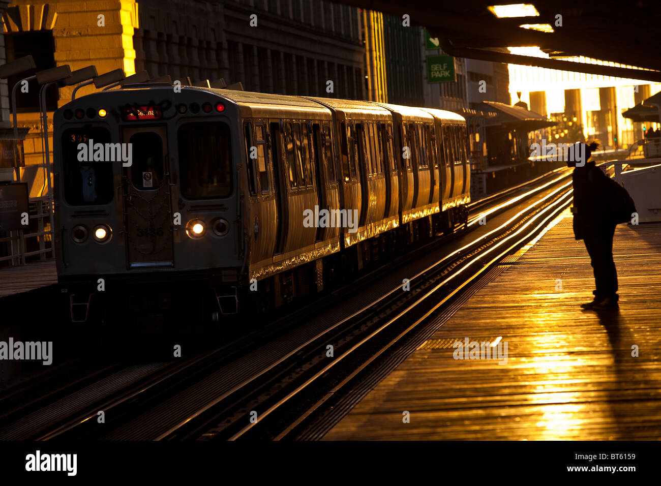 Sunrise illuminates the elevated tracks of the Chicago rapid transit ...