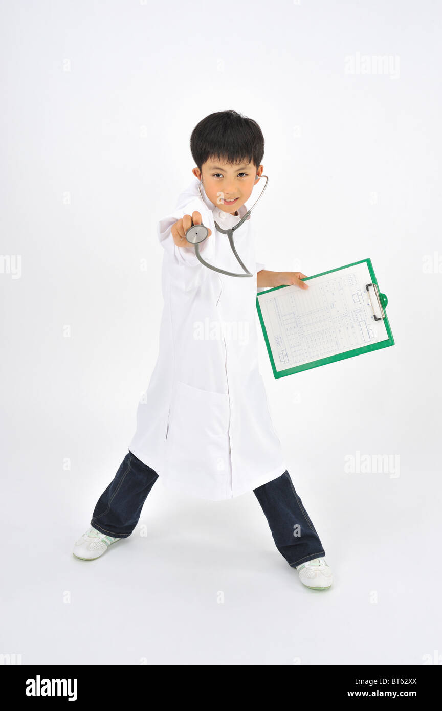 Boy playing as doctor Stock Photo - Alamy