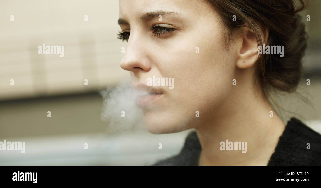 real young woman smokes on the street Stock Photo - Alamy
