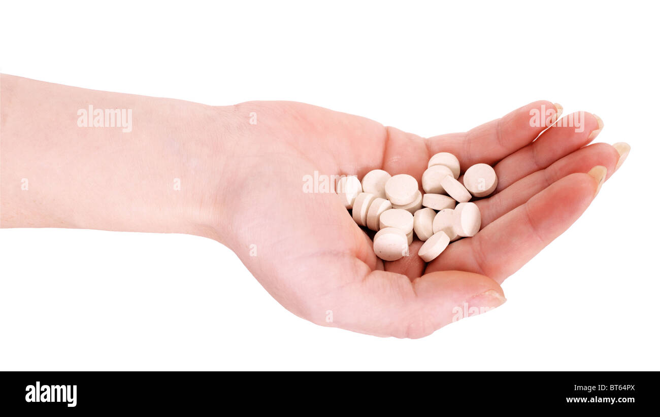 Handful of tablets on a female hand Stock Photo - Alamy