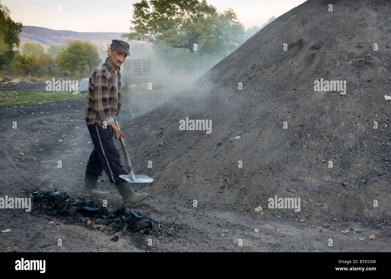 Charcoal burner in his traditional charcoal-burner's yard at Viscri ...