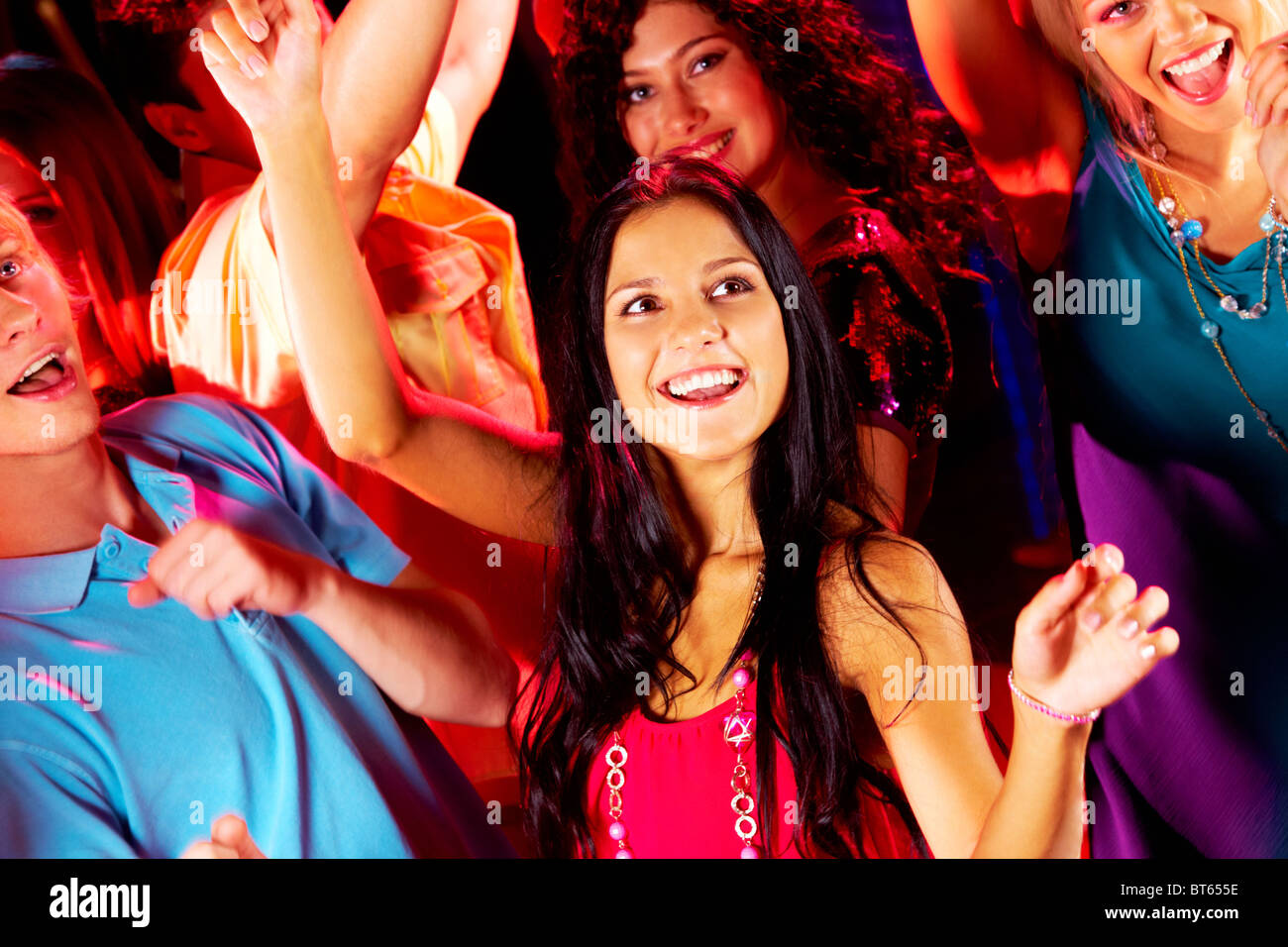 Joyful teens dancing in night club at party Stock Photo - Alamy