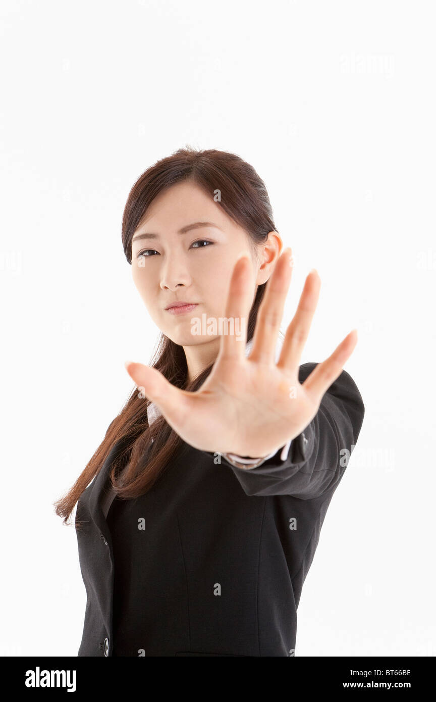 Businesswoman pushing out palm Stock Photo - Alamy