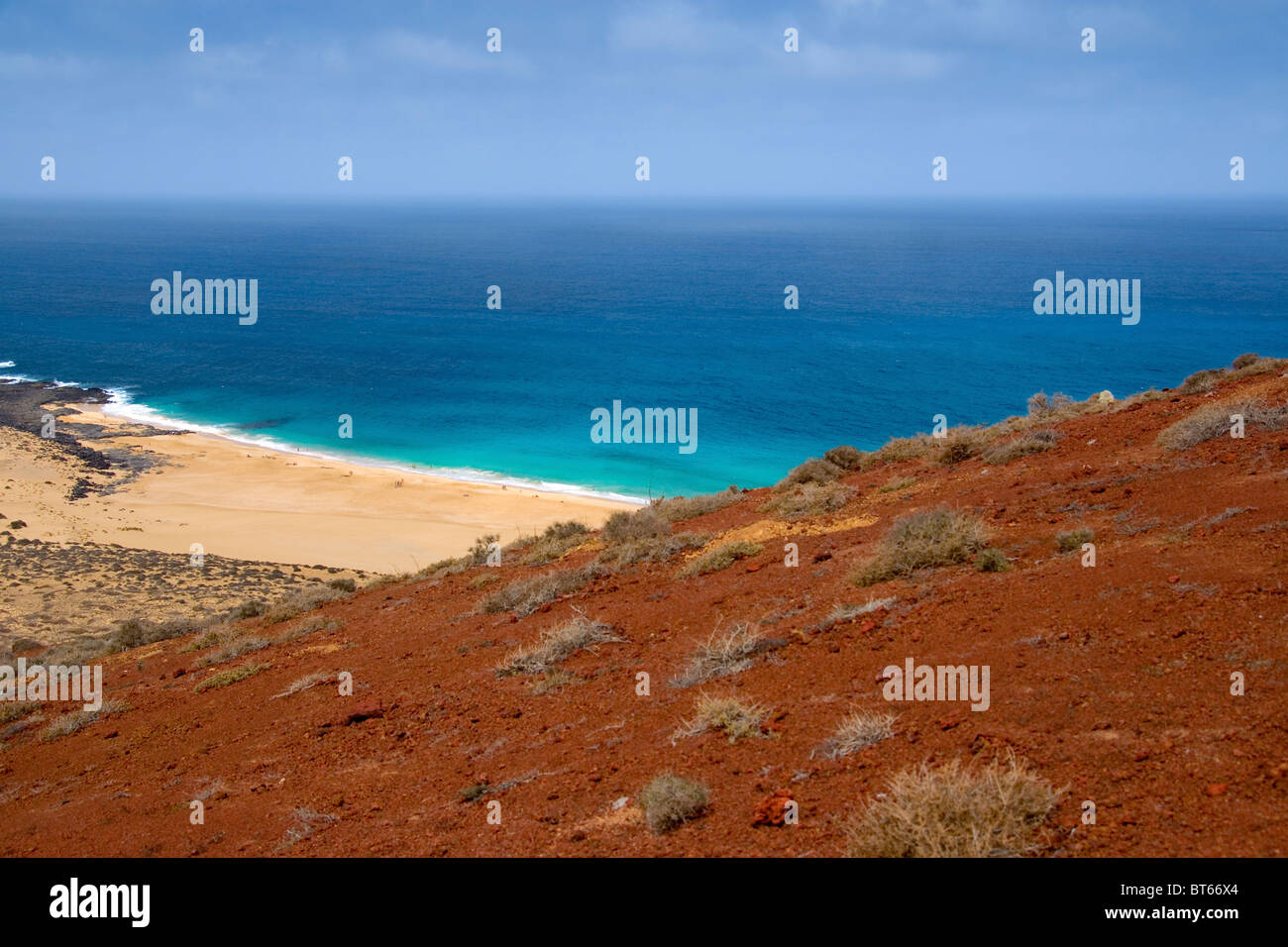 Sand beach under a red volcano in Lanzarote Stock Photo - Alamy