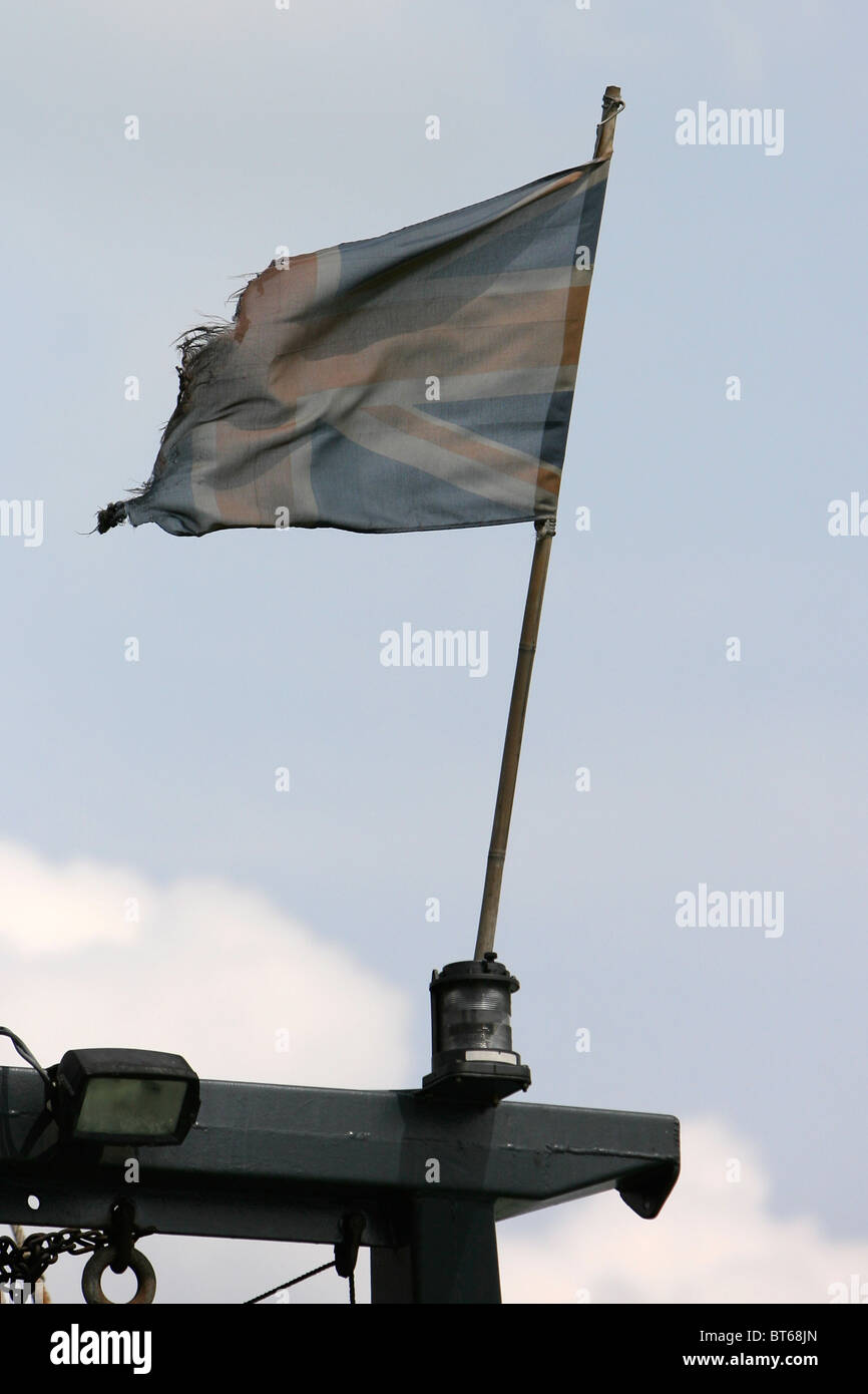 A decprepit Union Jack flag on a boat in a harbour in Brighton, England ...