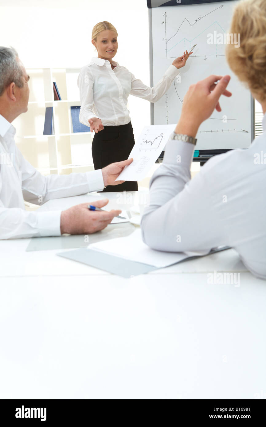 Photo of successful employee standing by whiteboard and presenting ...